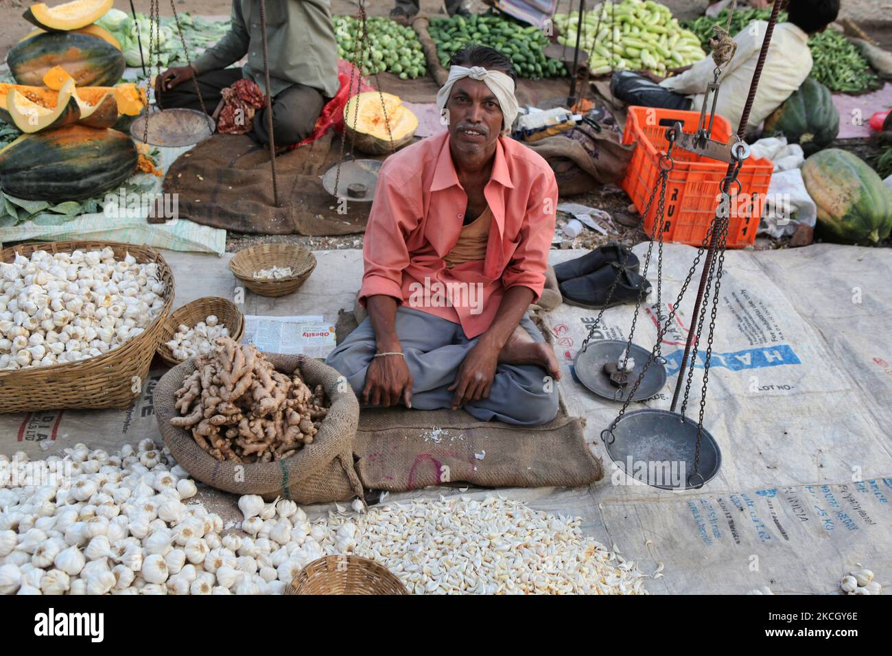 Man sells garlic and ginger at the Shaniwaar Subzi Bazaar, which is the ...