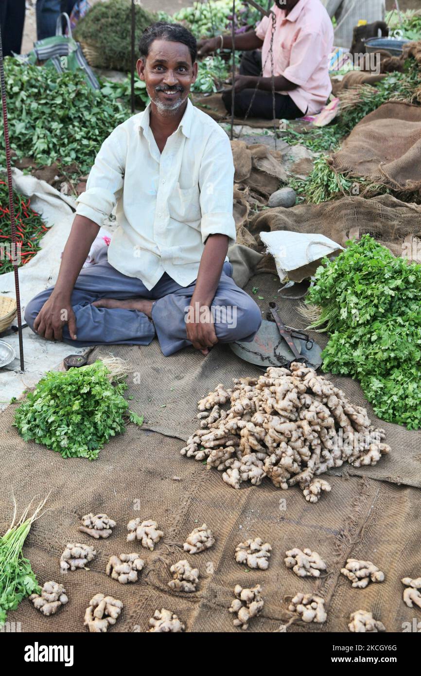 Man sells turmeric and coriander at the Shaniwaar Subzi Bazaar, which is the largest fruit and ...