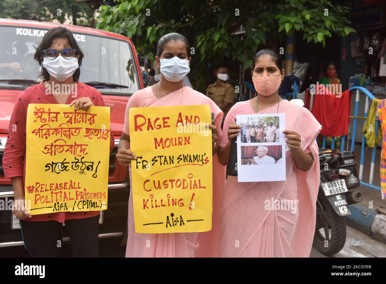 Protesters along with two Christian Nuns stand holding a placards ...
