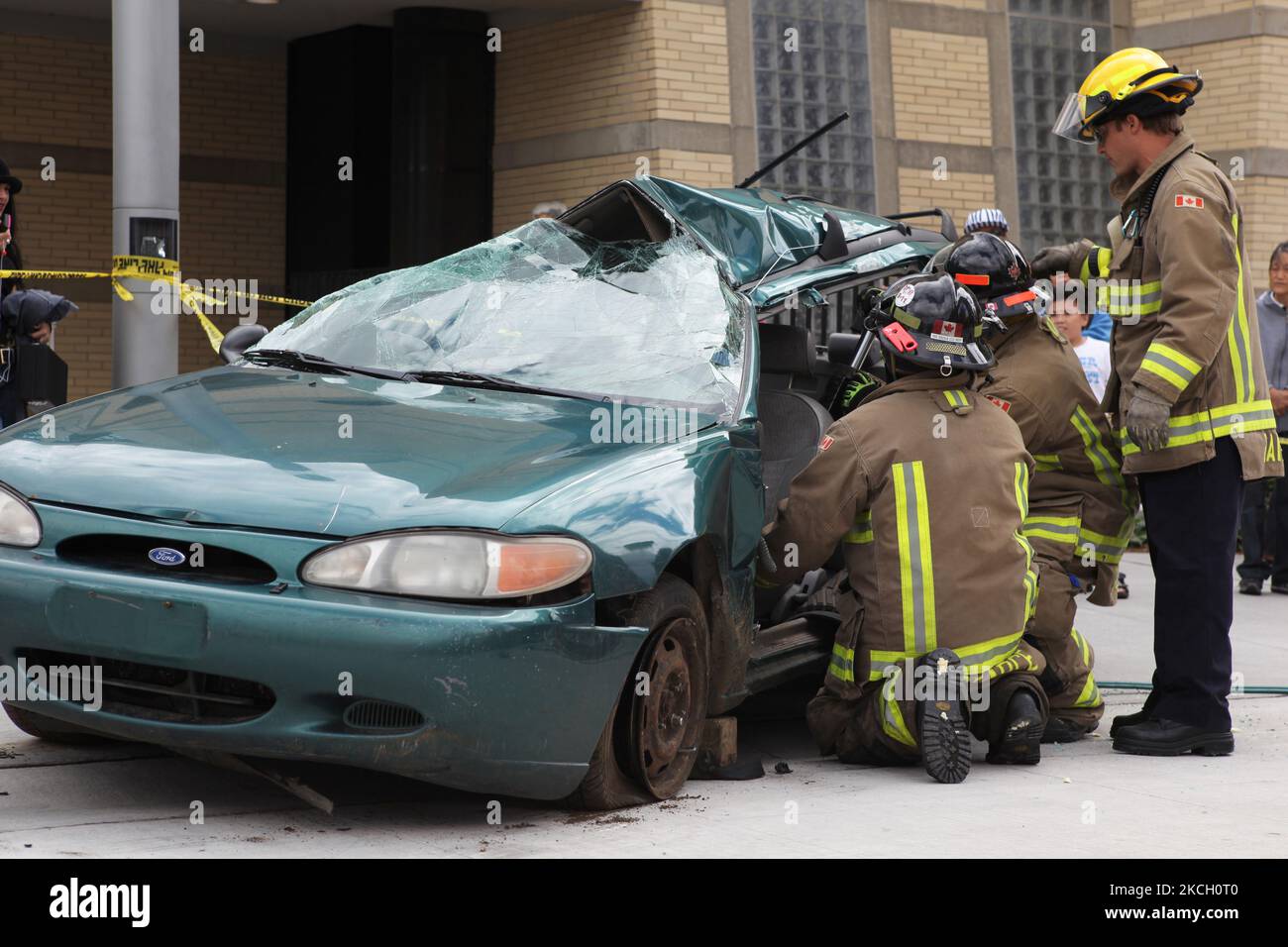 Firefighters prepare to remove the doors of a vehicle using the 'jaws ...