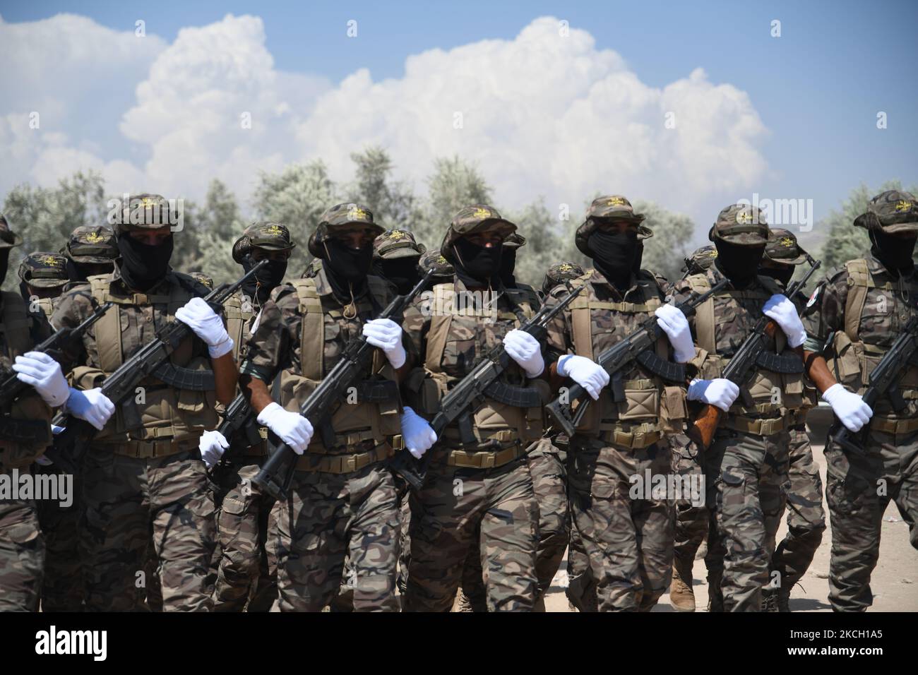 Syrian fighters march in columns, ride dirt bikes and and drive pick-up ...