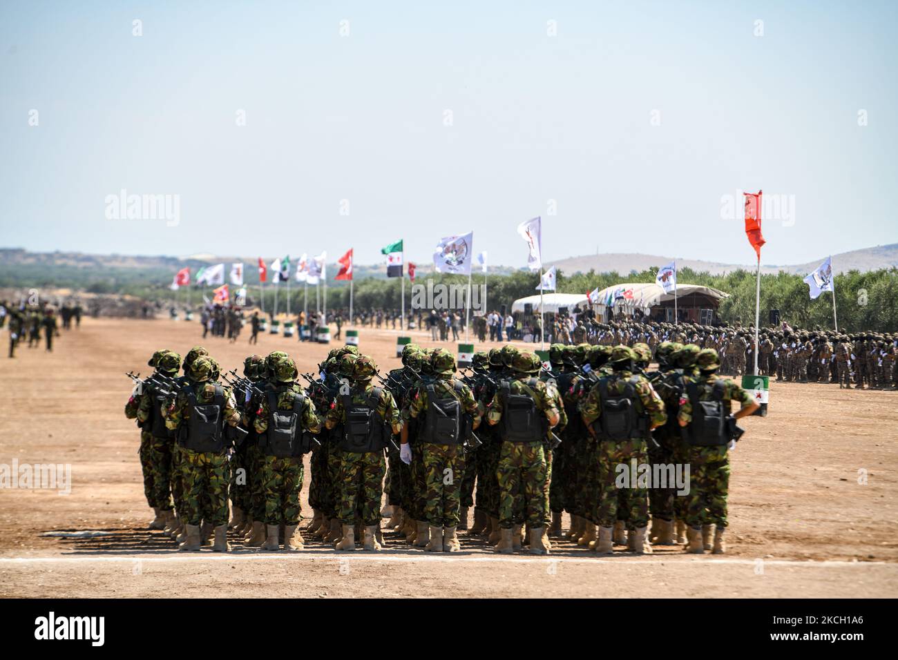Syrian fighters march in columns, ride dirt bikes and and drive pick-up ...