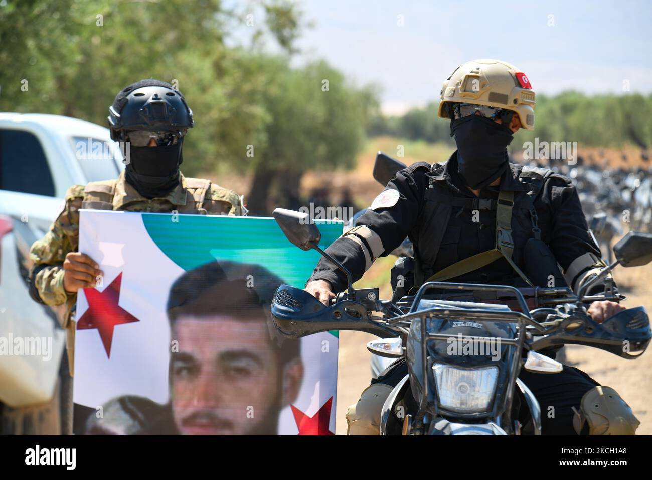 Syrian fighters march in columns, ride dirt bikes and and drive pick-up ...