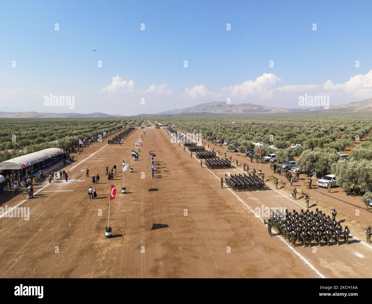 Syrian fighters march in columns, ride dirt bikes and and drive pick-up ...