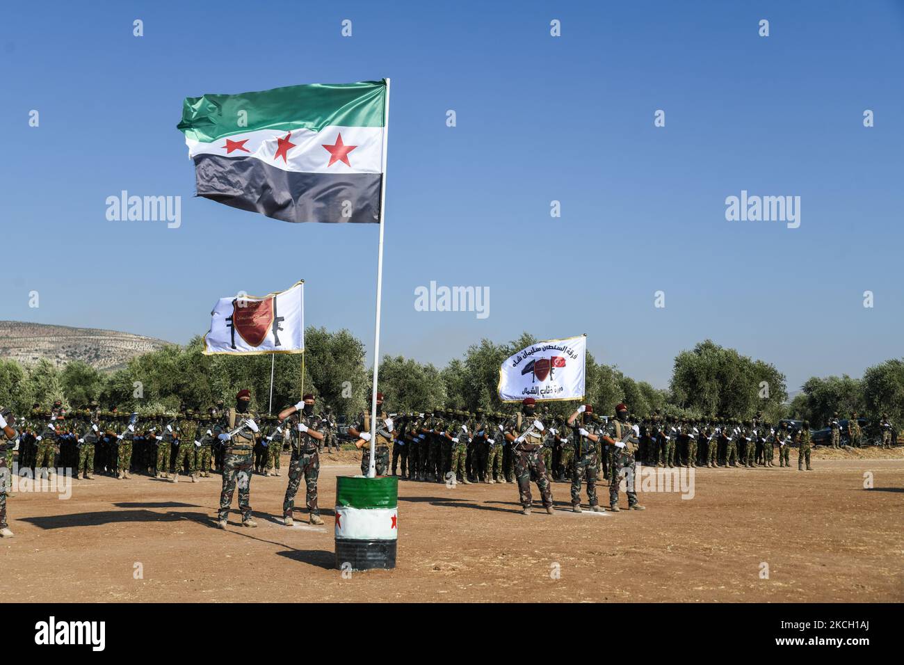 Syrian fighters march in columns, ride dirt bikes and and drive pick-up ...