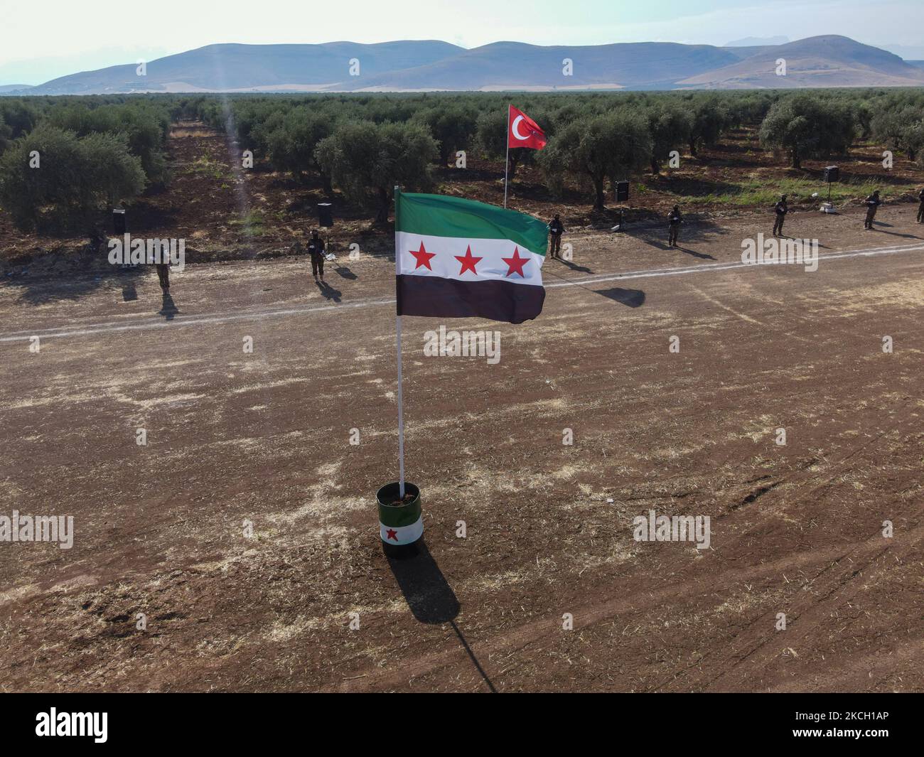 Syrian fighters march in columns, ride dirt bikes and and drive pick-up ...