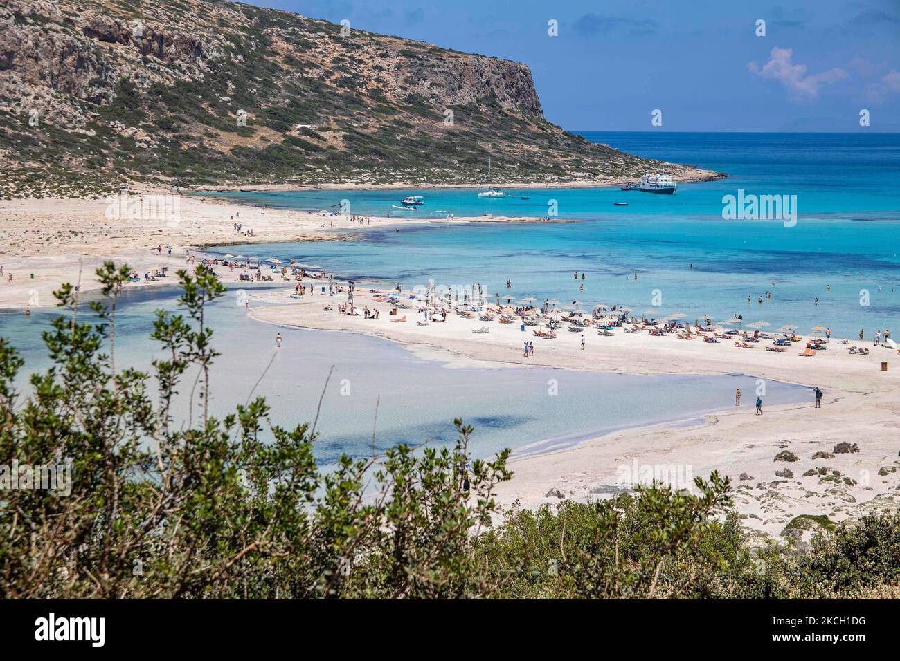 Panoramic view of Balos Beach with the umbrellas, sundecks, people ...