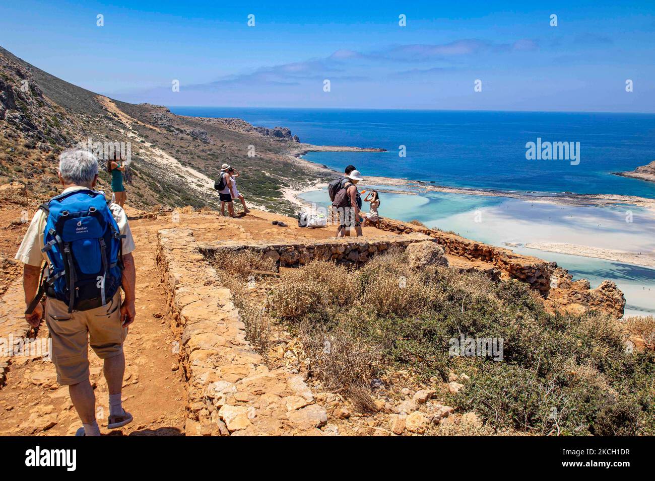 Tourists enjoying the view of Balos while they are walking on the path ...