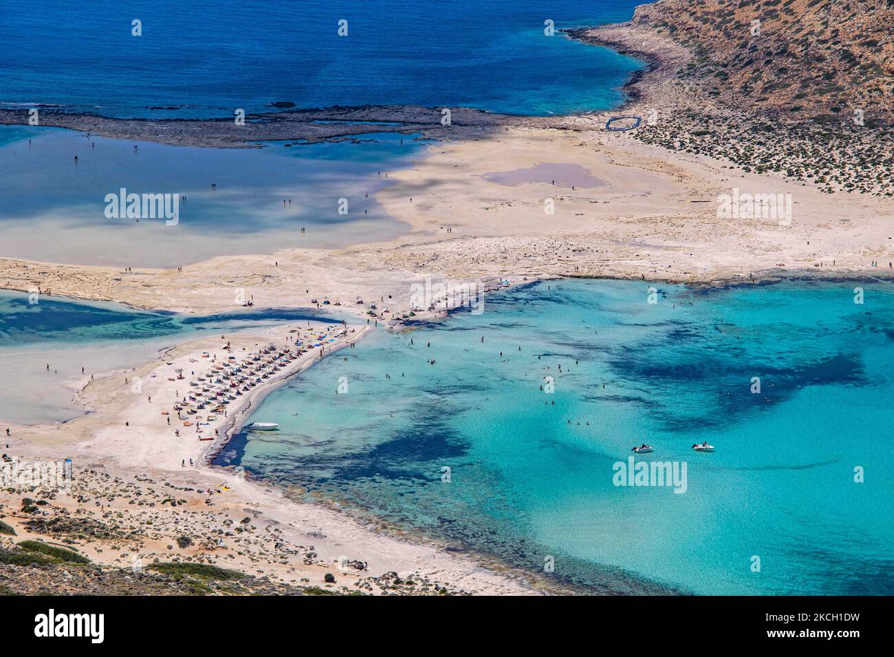 Panoramic view of Balos Beach with the umbrellas, sundecks and people ...