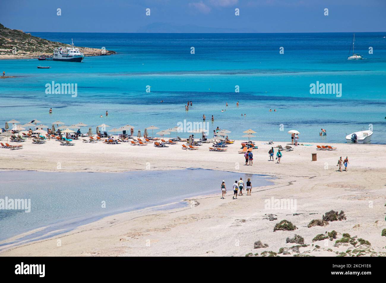 Panoramic view of Balos Beach with the umbrellas, sundecks, people ...