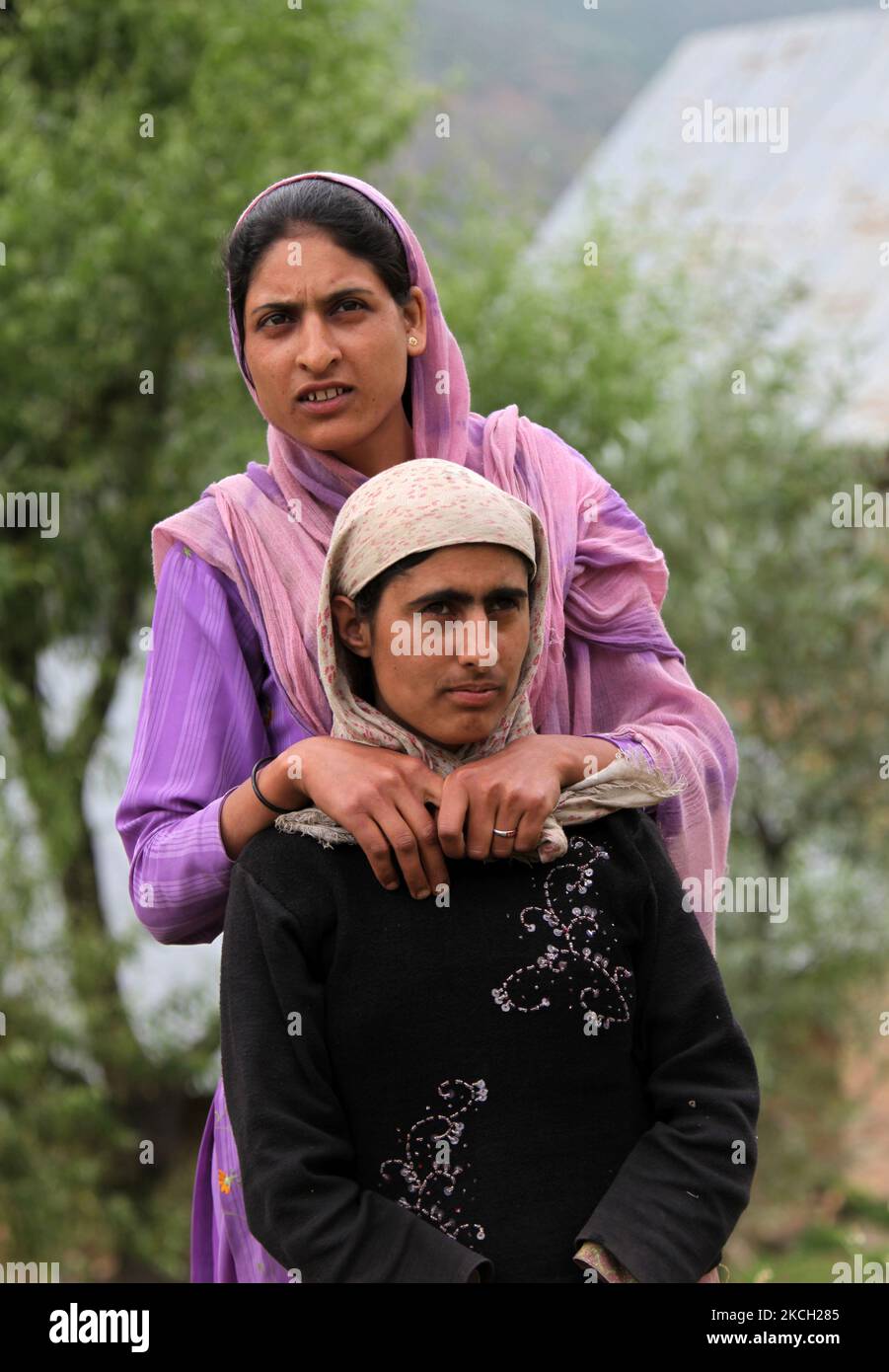 Muslim Kashmiri sisters in traditional outfits in the village of Kangan ...