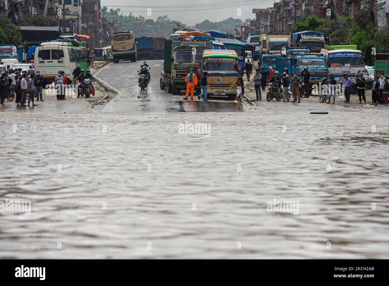 Vehicles stuck for hours to cross the inundated road section after a ...