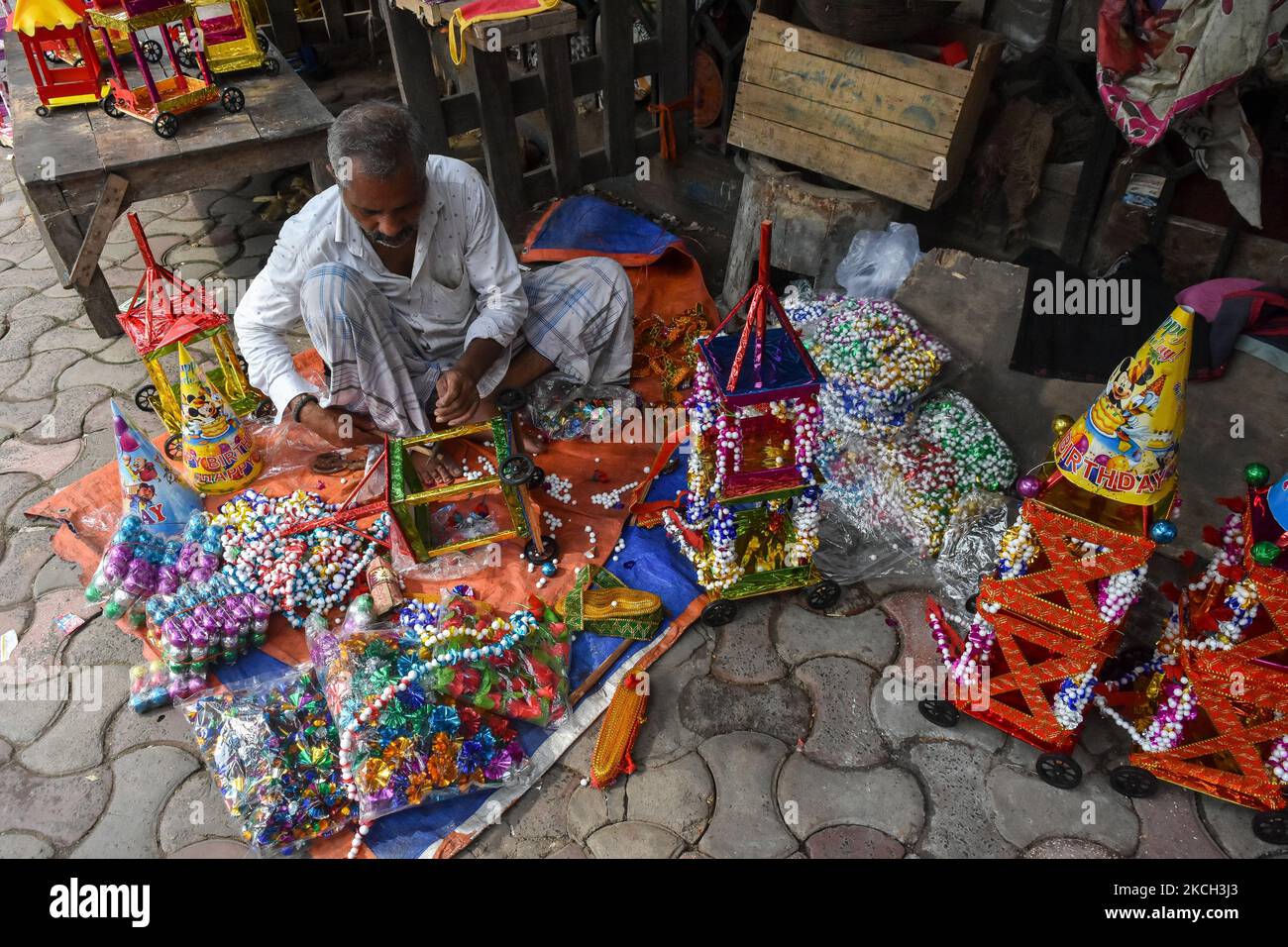 A man decorates a chariot ahead of Rath-yatra celebration in Kolkata ...