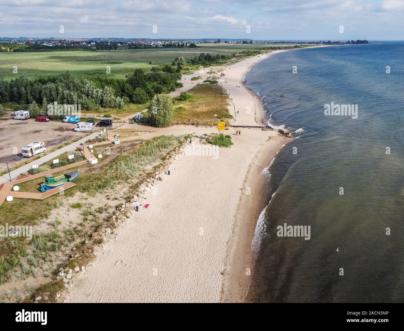 General view of the Gdansk Bay sandy beach with an algae and seaweed in ...