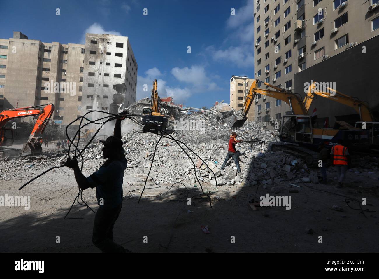 Egyptian workers and machines clear the remaining rubble of Al-Jalaa ...