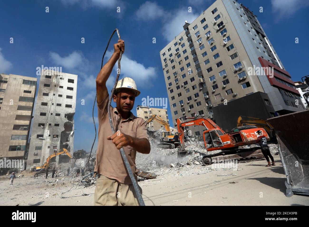 Egyptian workers and machines clear the remaining rubble of Al-Jalaa ...
