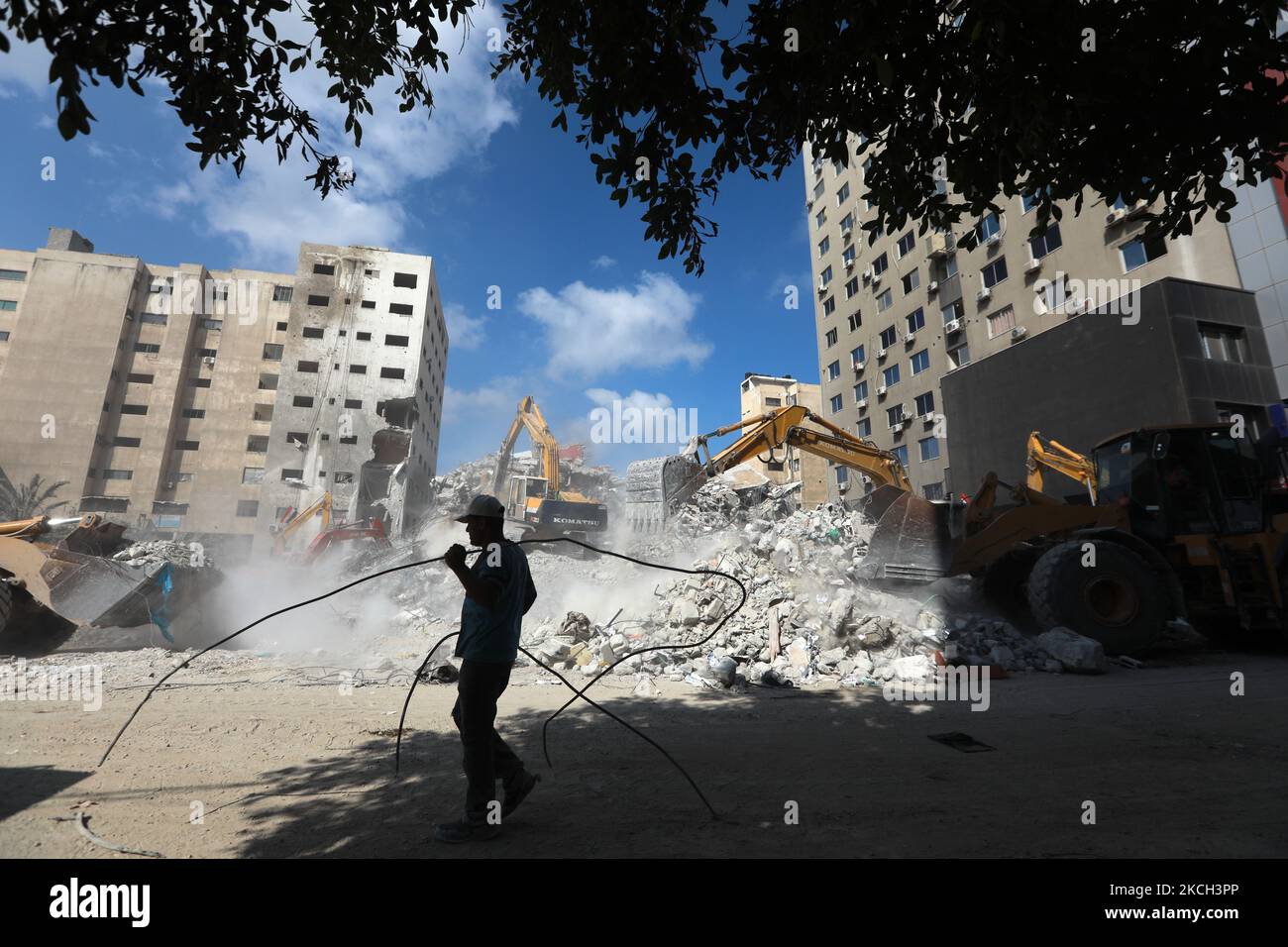 Egyptian workers and machines clear the remaining rubble of Al-Jalaa ...