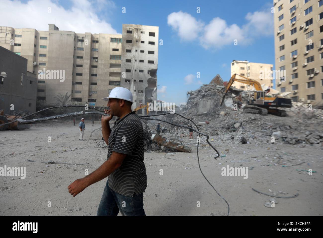 Egyptian workers and machines clear the remaining rubble of Al-Jalaa ...