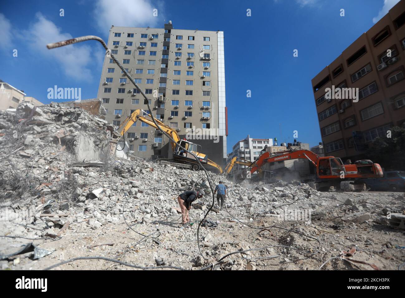 Egyptian workers and machines clear the remaining rubble of Al-Jalaa ...