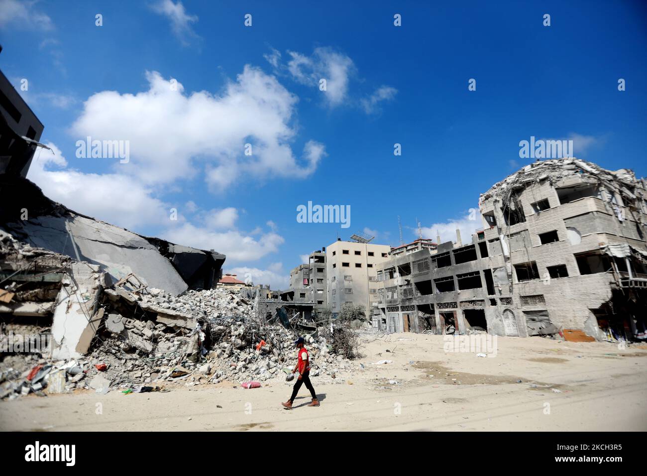 Workers clear the remaining rubble of the Al-Shuruq tower, a building ...