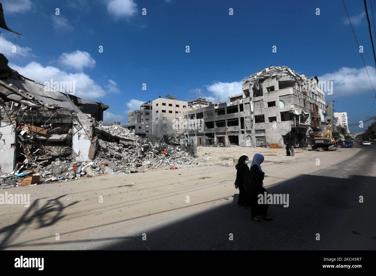Workers clear the remaining rubble of the Al-Shuruq tower, a building ...