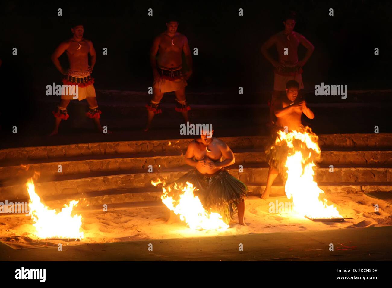 Polynesian men perform a traditional fire dance in O'ahu, Hawaii, USA ...