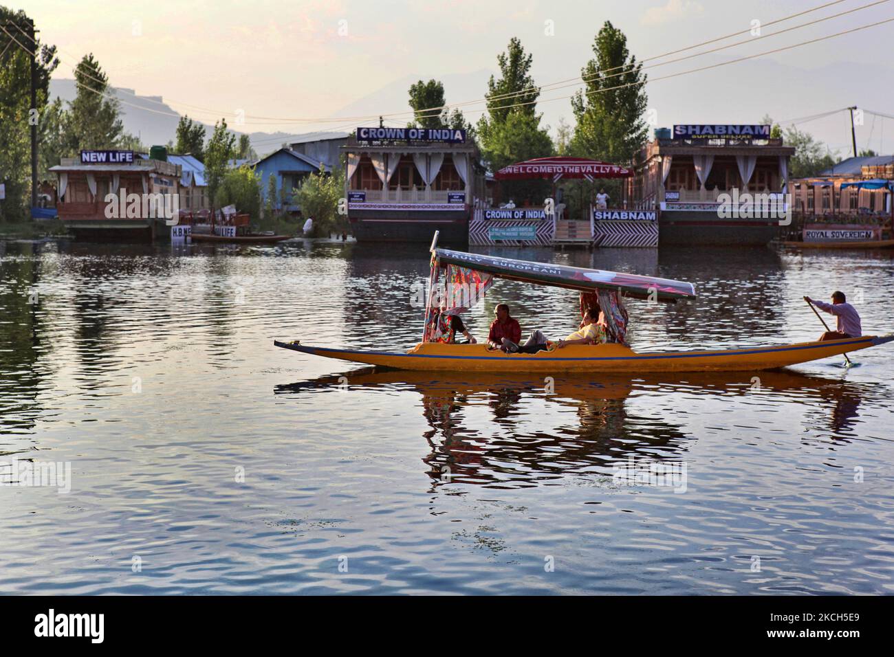 Shikara boatman ferries Indian tourists on Kashmir's famous Dal Lake in Srinagar, Kashmir, India ...