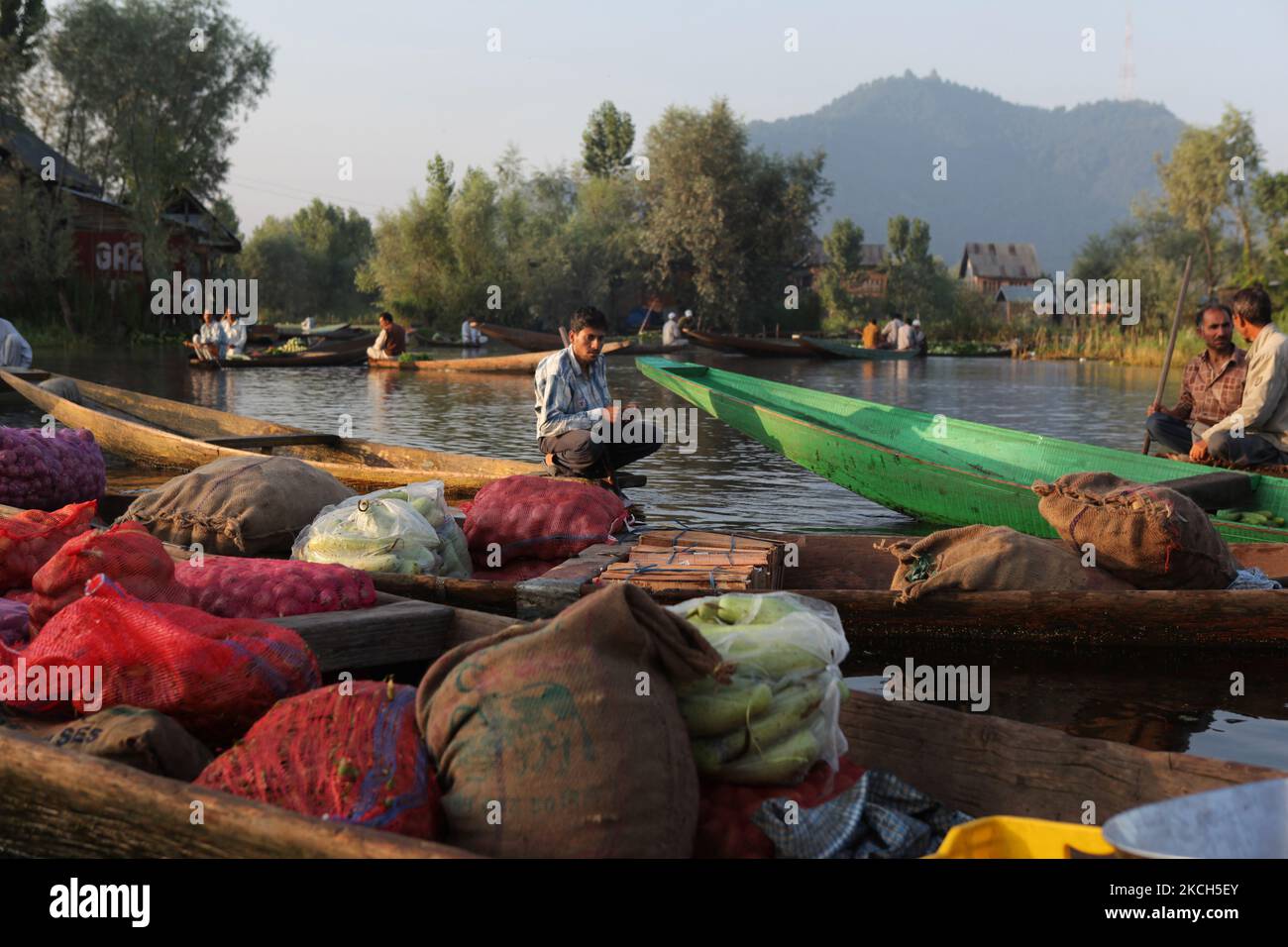 Merchants and shoppers at the floating vegetable market on Dal Lake in ...