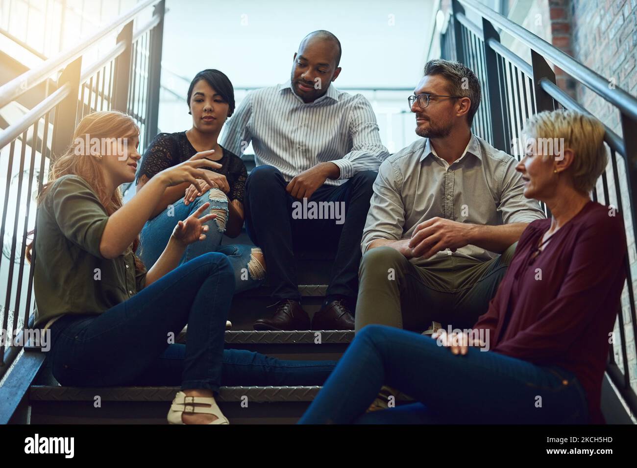 We keep expanding. a group of business colleagues sitting outside on ...