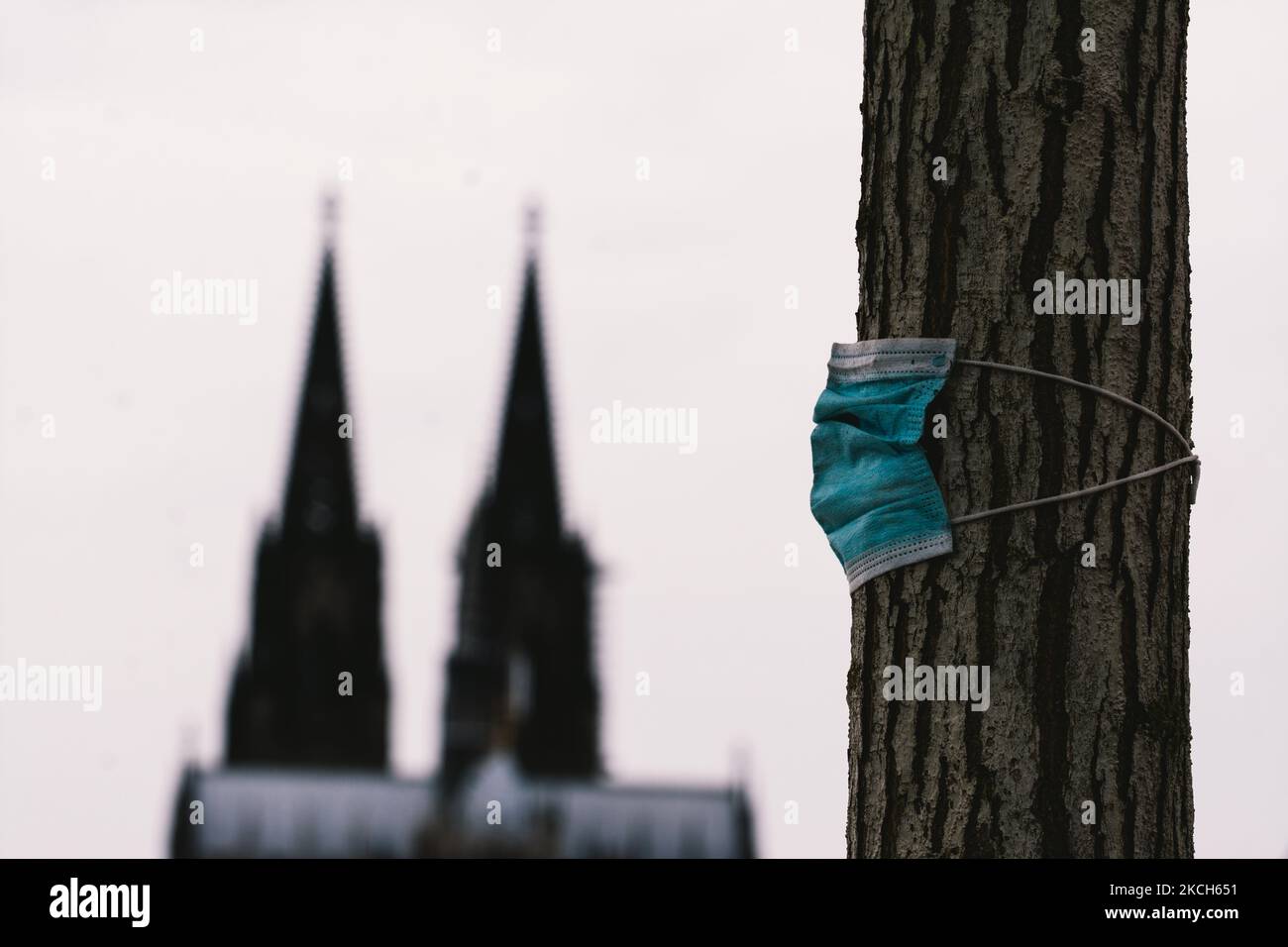a mask is seen stapled on a tree in Cologne, Germany on July 12, 2021 ...