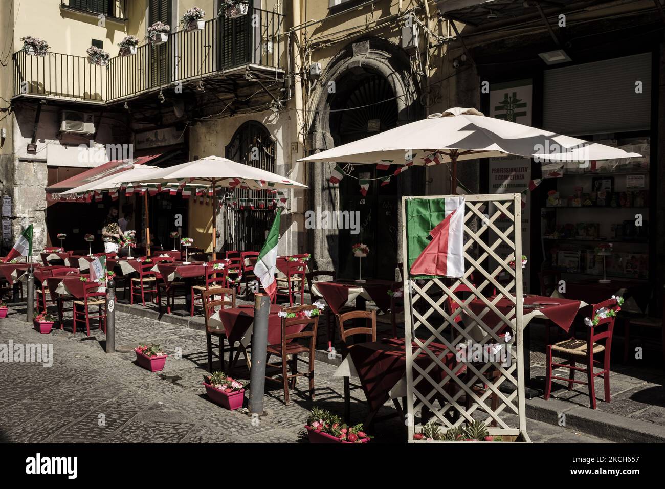 A restaurant is decorated with flags of the Italian nation to support ...