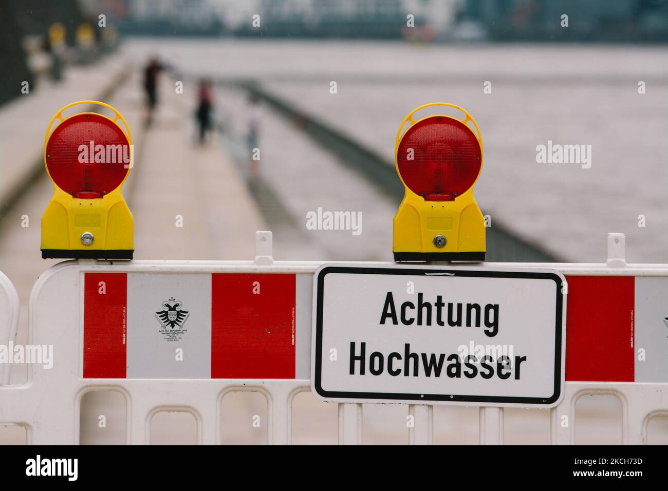 Warns sign against flood is seen along rhine promenade in Cologne ...