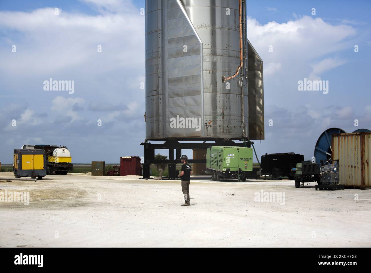 A SpaceX employee stands next to Starship SN15 on July 13th, 2021 in ...