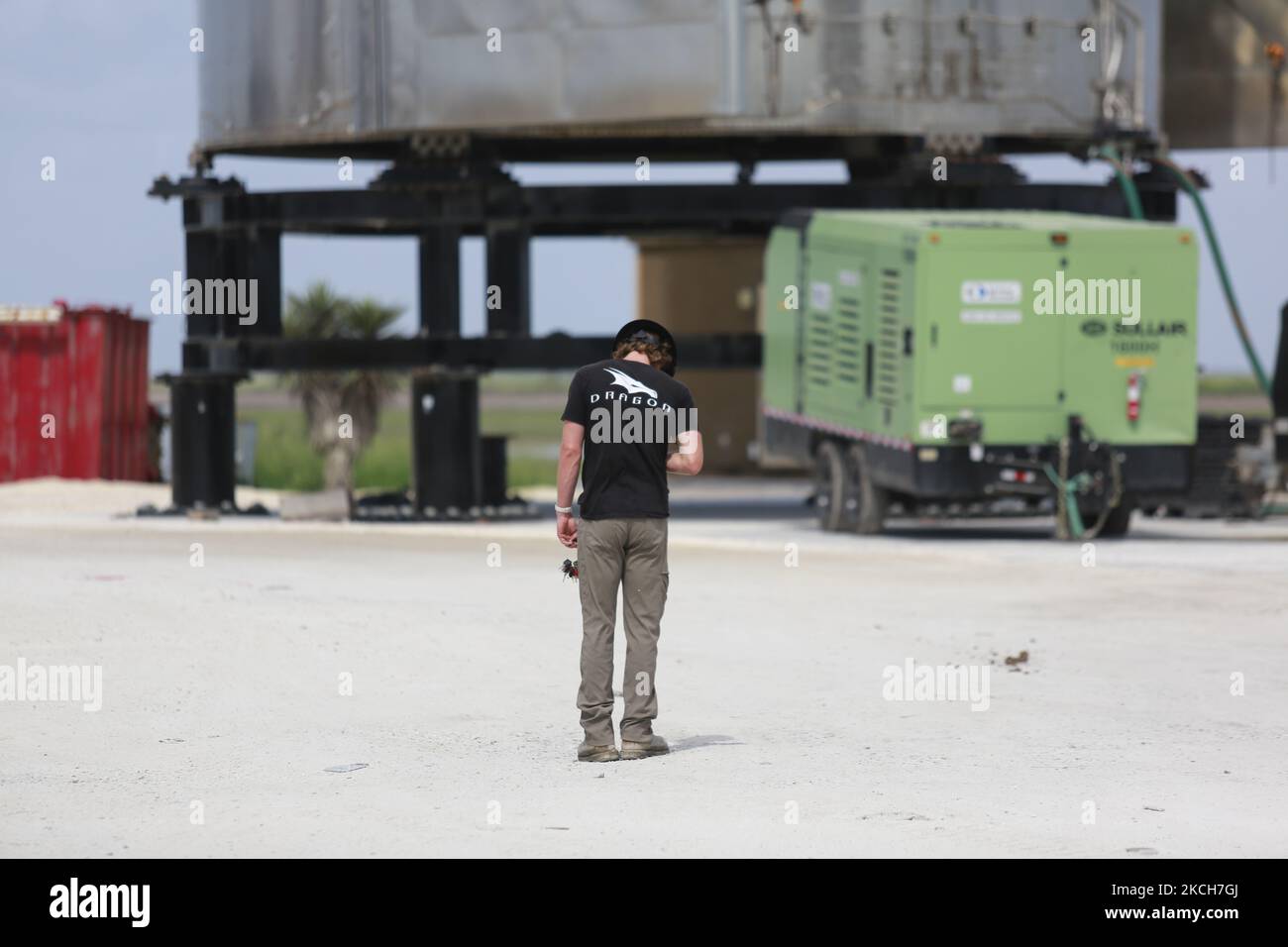 A SpaceX employee stands next to Starship SN15 on July 13th, 2021 in ...