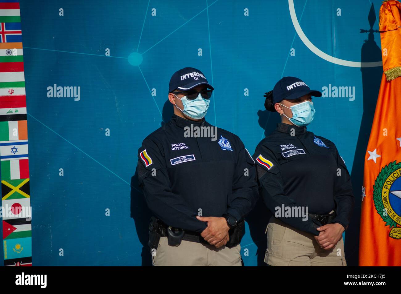 Officers of Interpol International police stand during a press ...