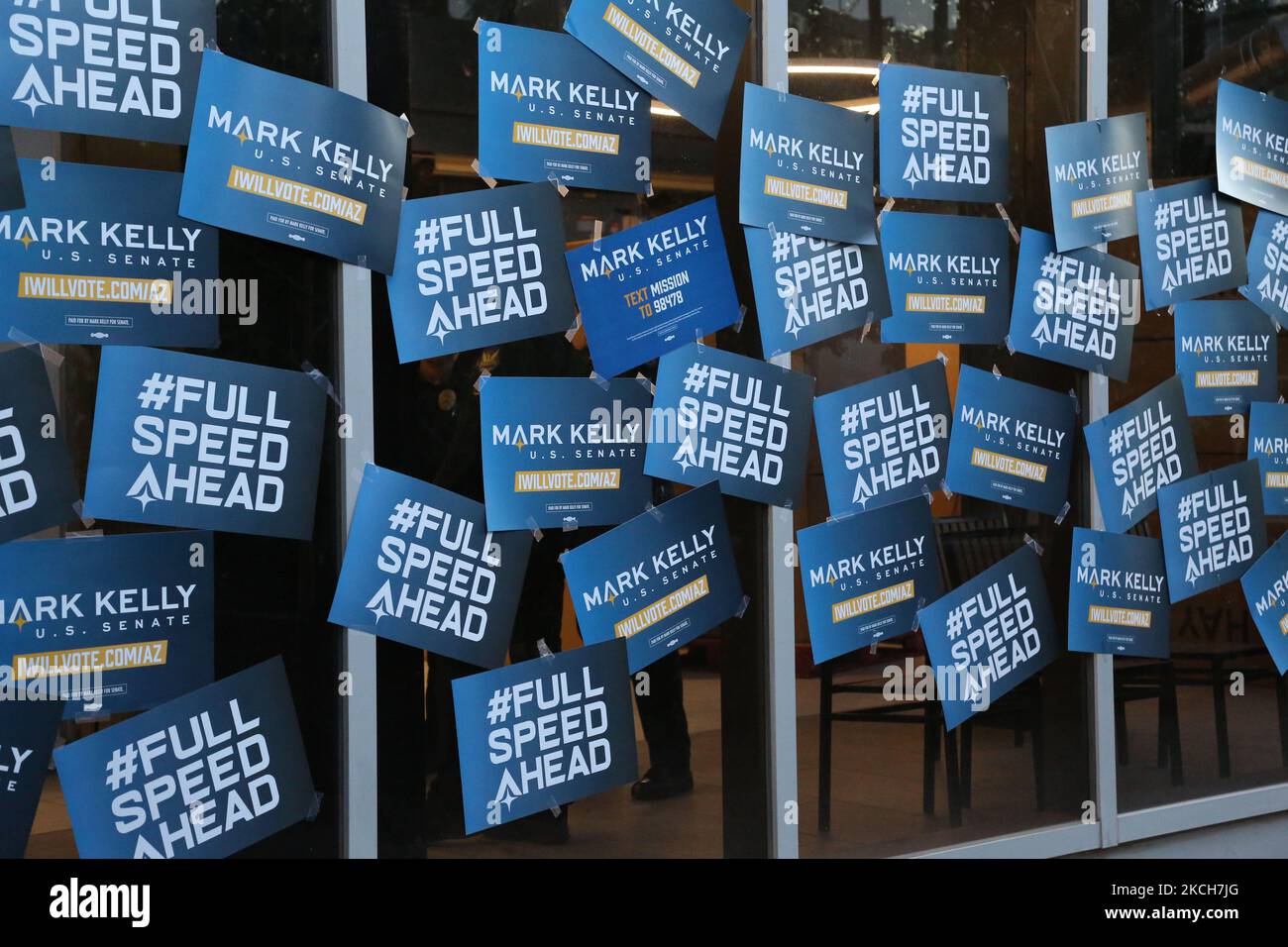 Mark Kelly campaign signs on a window at the event that featured ...