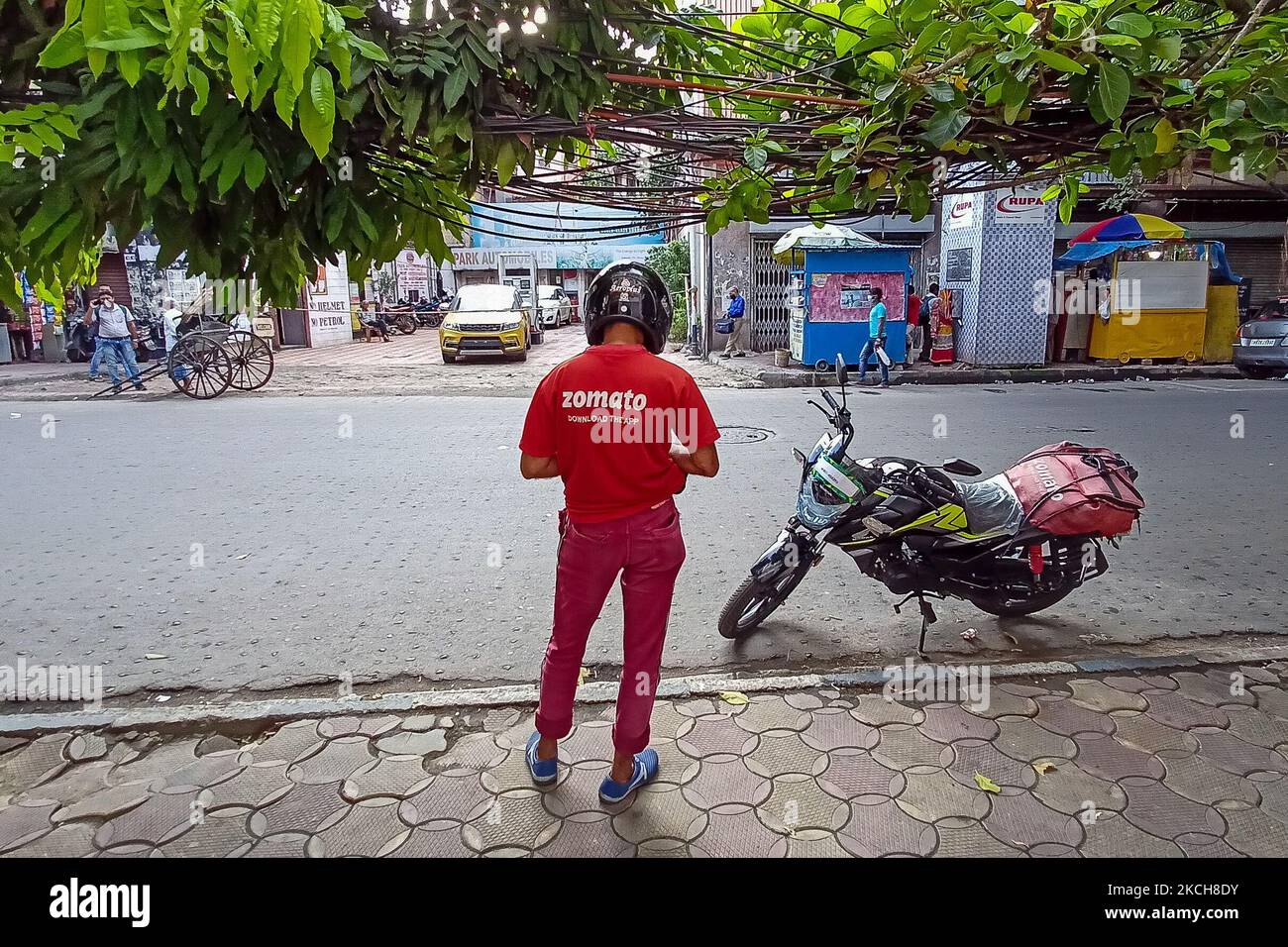 A ZOMATO food delivery partner is seen on a road in Kolkata , India ...