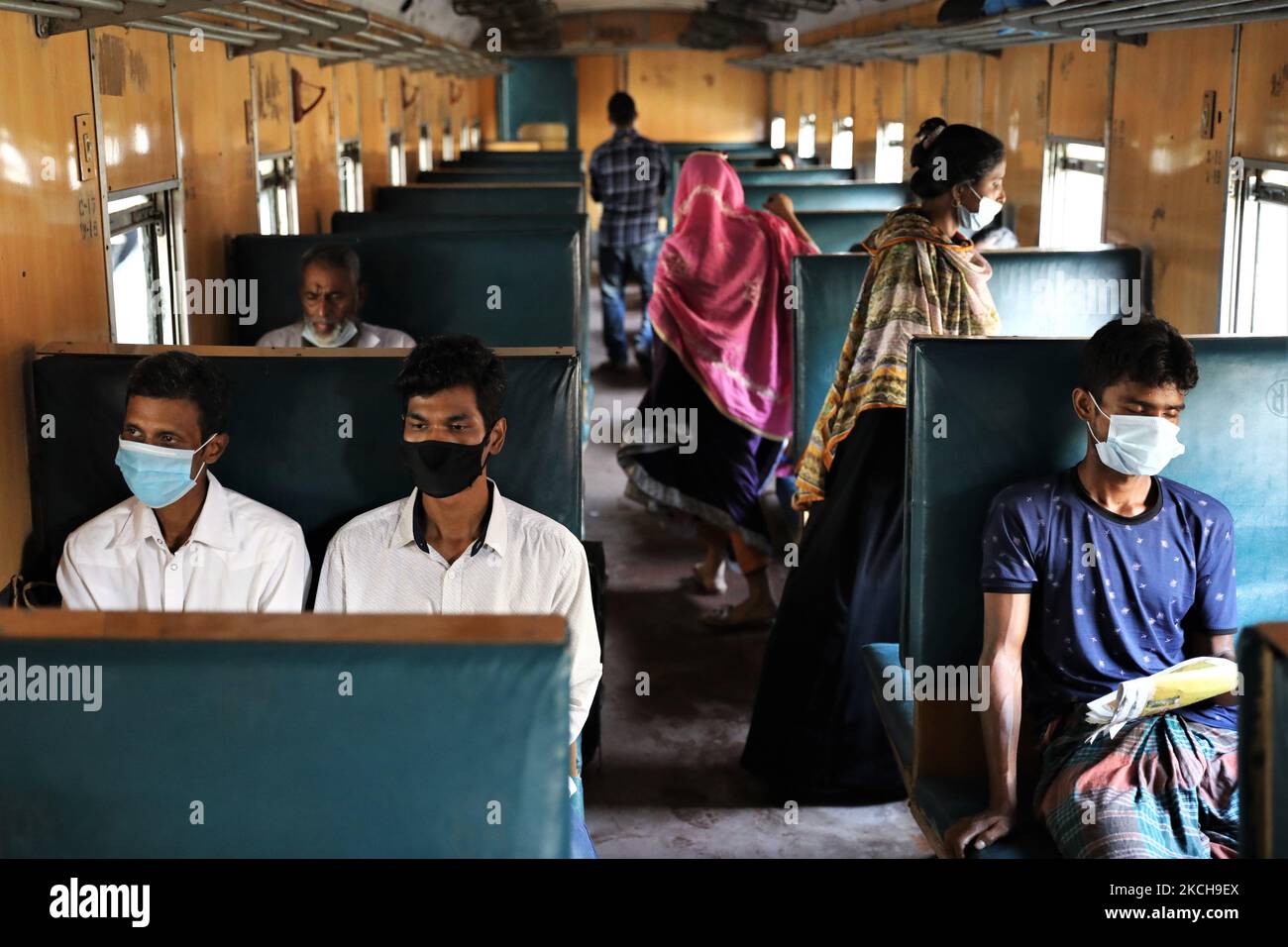 People wear masks as they travel on a train after the withdrawal of the ...