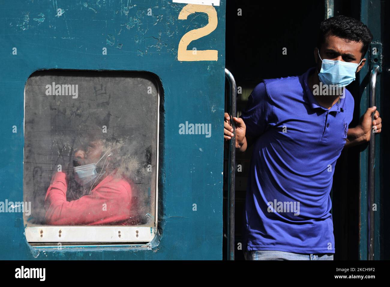 People wear masks as they travel on a train after the withdrawal of the ...