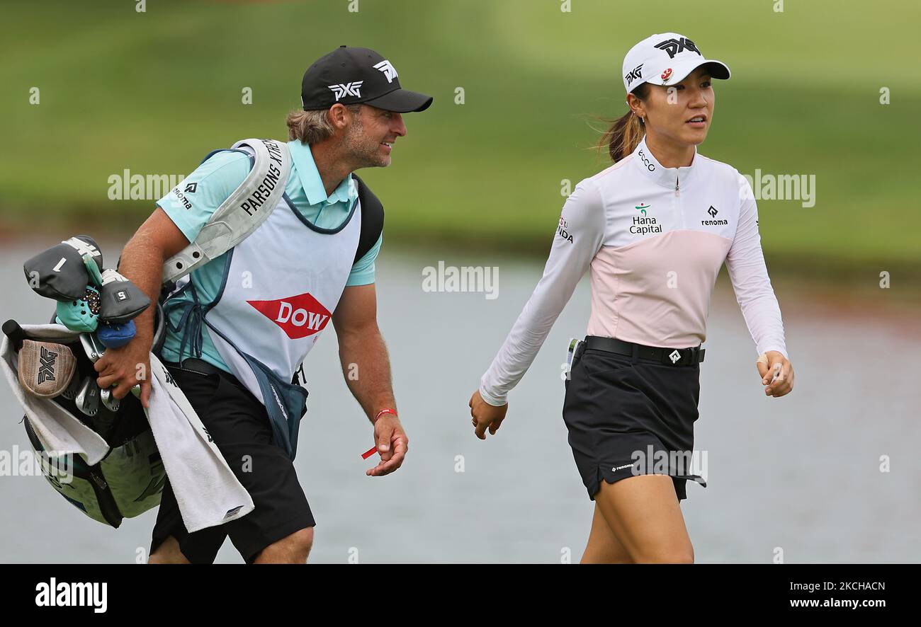 Lydia Ko of Australia walks to the 13th green with her caddy during the ...