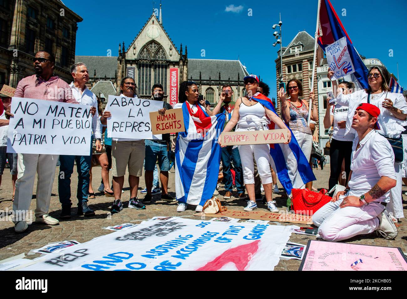 Cuban People Are Wearing Cuban Flags And Holding Placards While