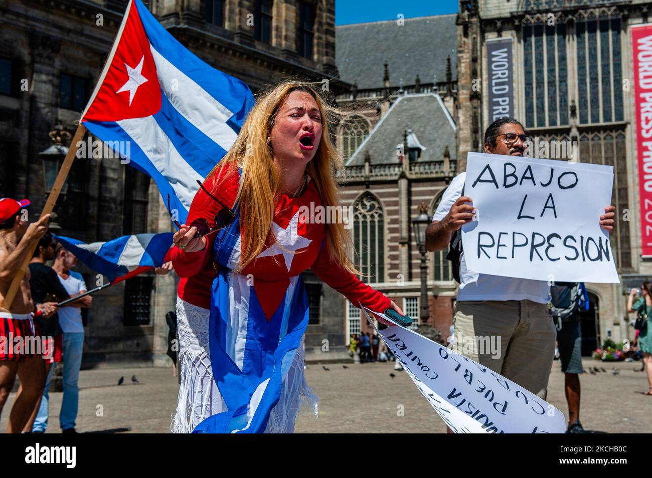 A woman wearing the Cuban flag is giving an emotional speech, during ...