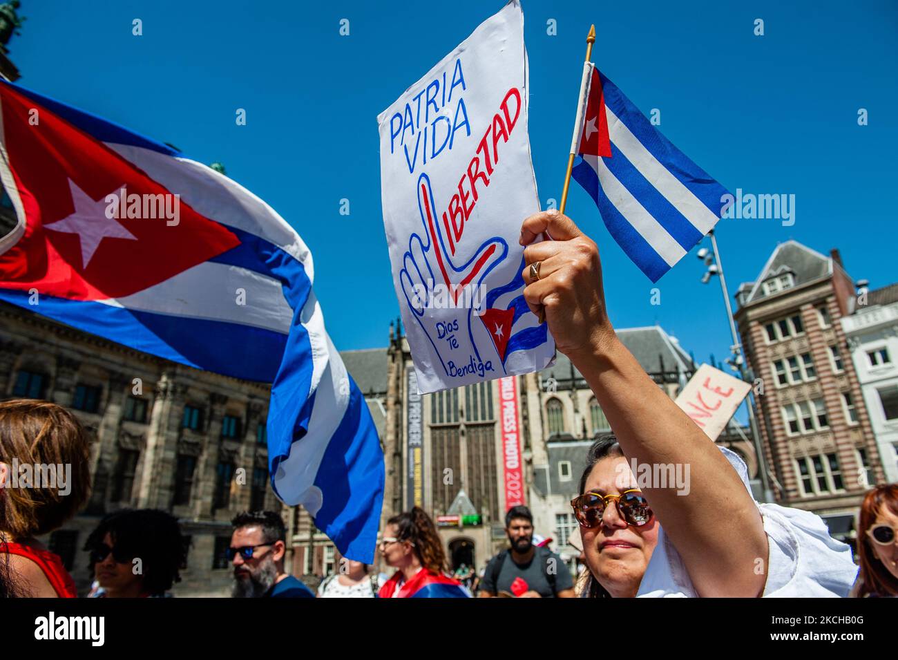 A woman is holding a placard asking for freedom for Cuba and a Cuban ...
