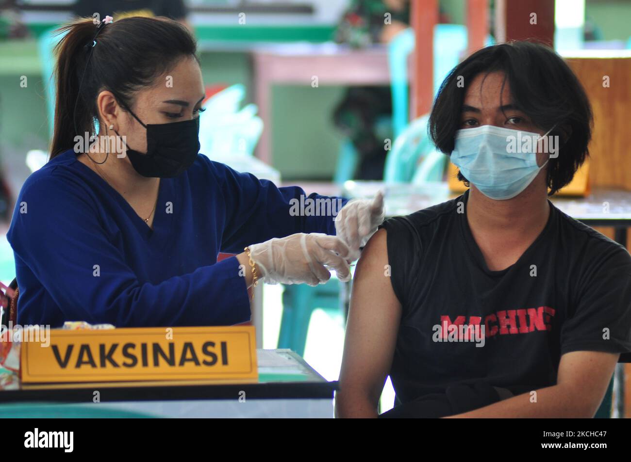 A teenage boy is being injected with a vaccine to prevent exposure to ...