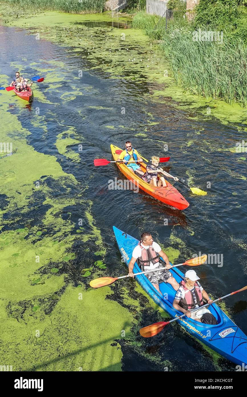 People kayaking in kayaks by the Motlawa river canal are seen in Gdansk ...