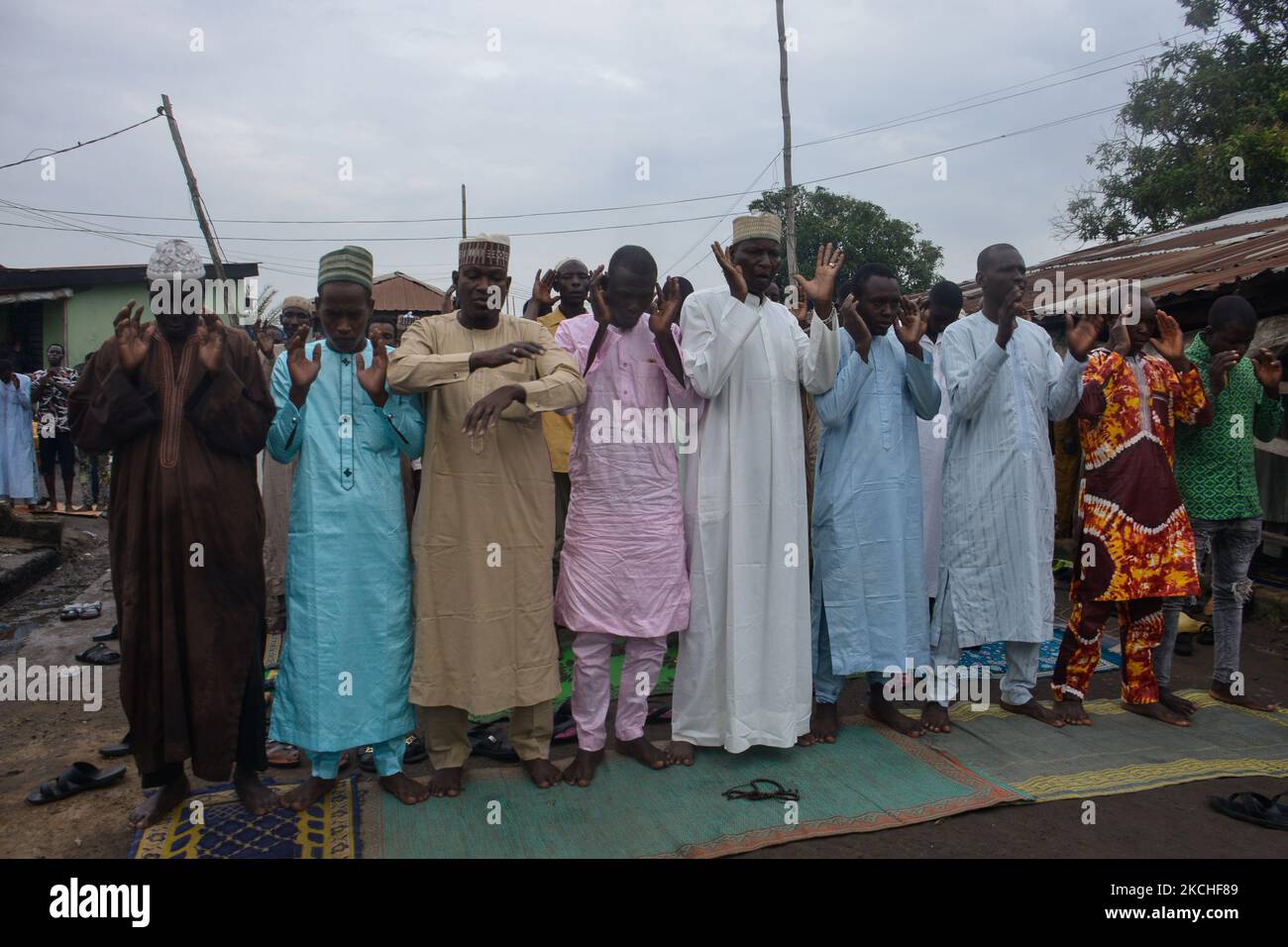 Muslim devotees prayer outside the kara Cattle Market Mosque as they ...