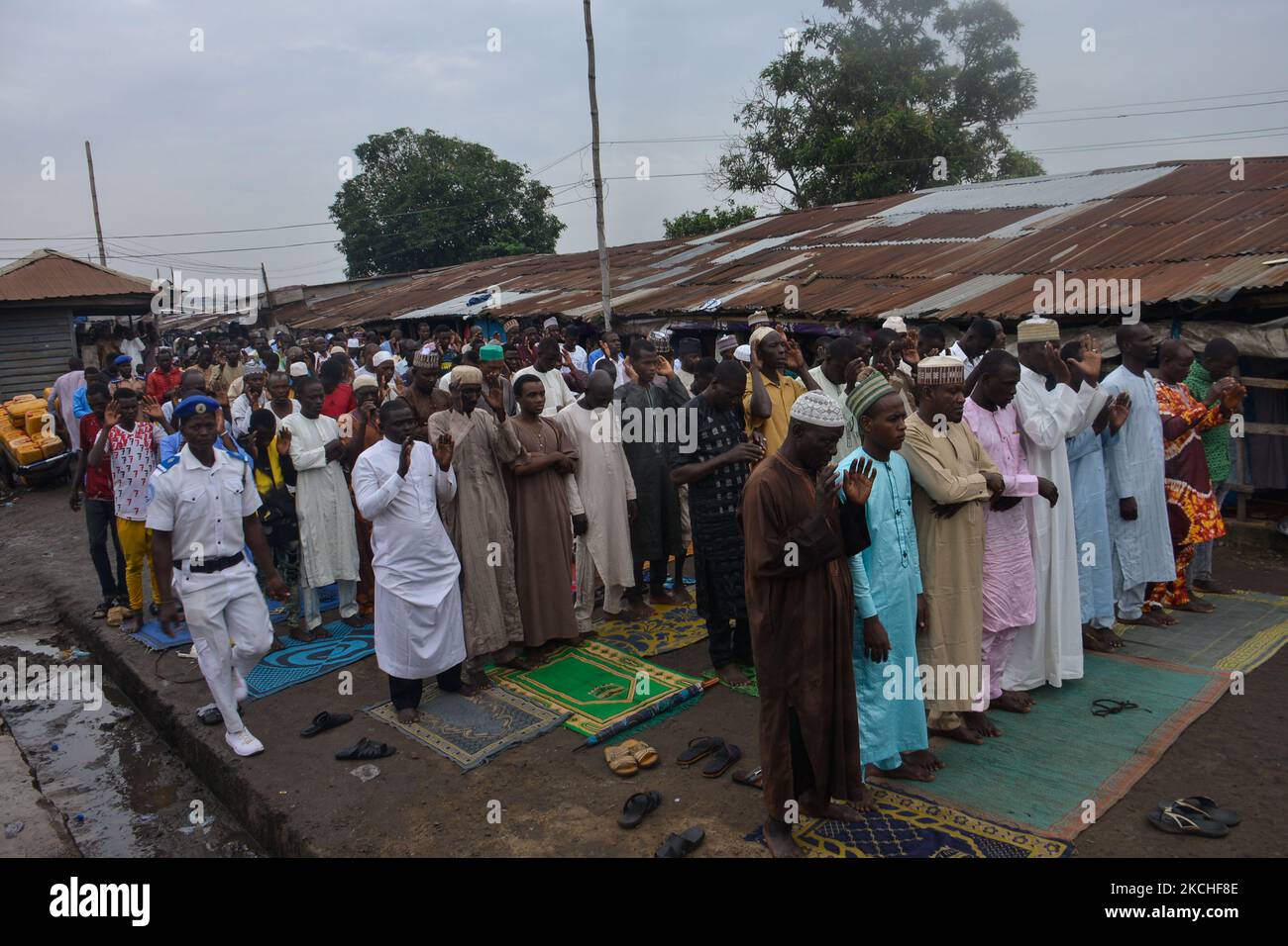 Muslim devotees prayer outside the kara Cattle Market Mosque as they ...