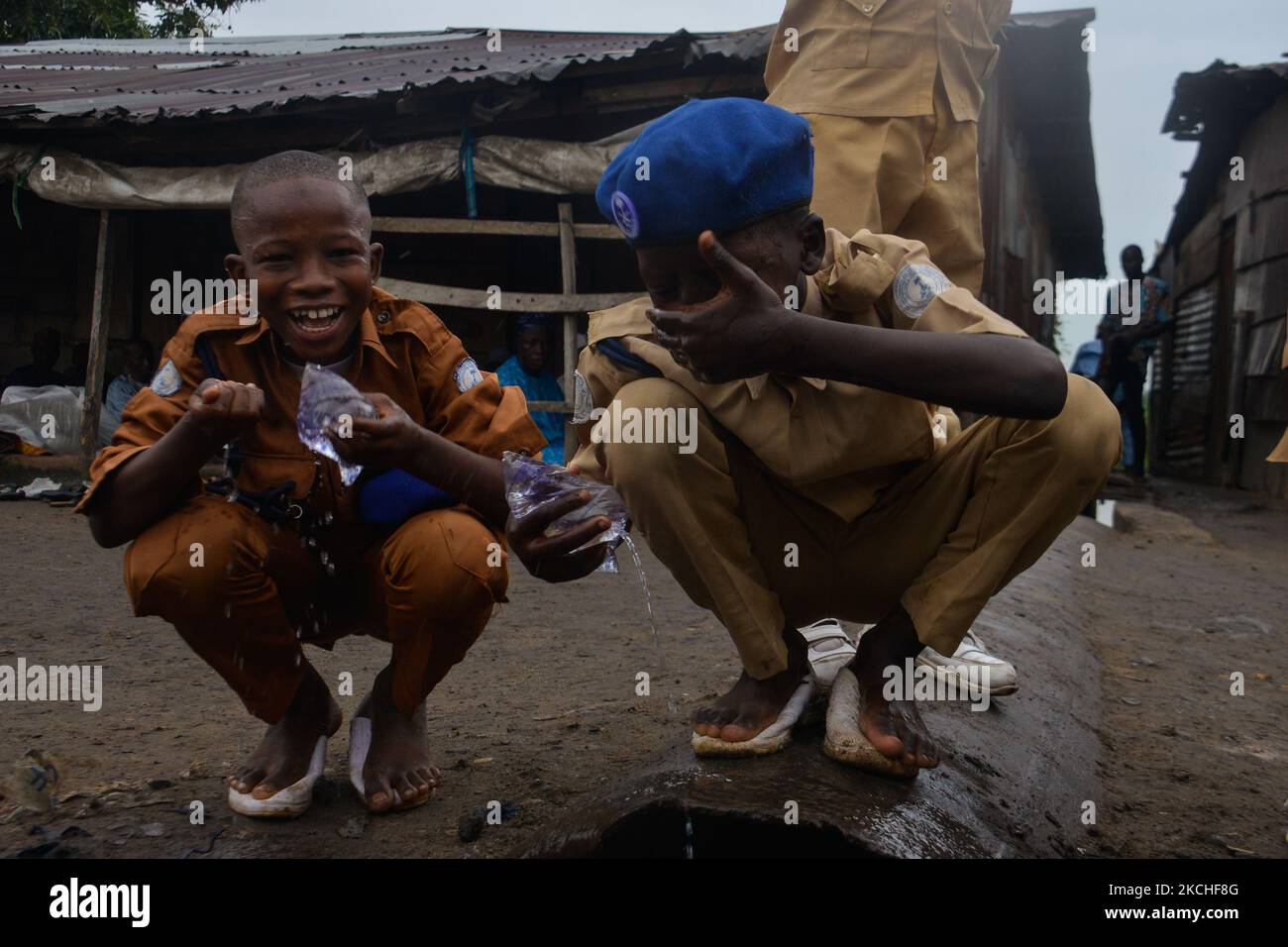 Two boys performs the ritual ablutions before praying at the kara ...