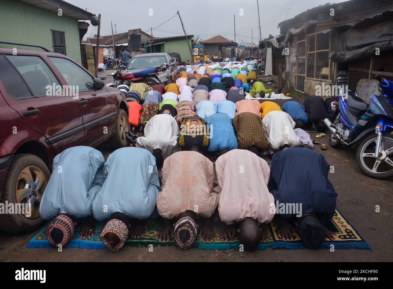 Muslim devotees prayer outside the kara Cattle Market Mosque as they ...