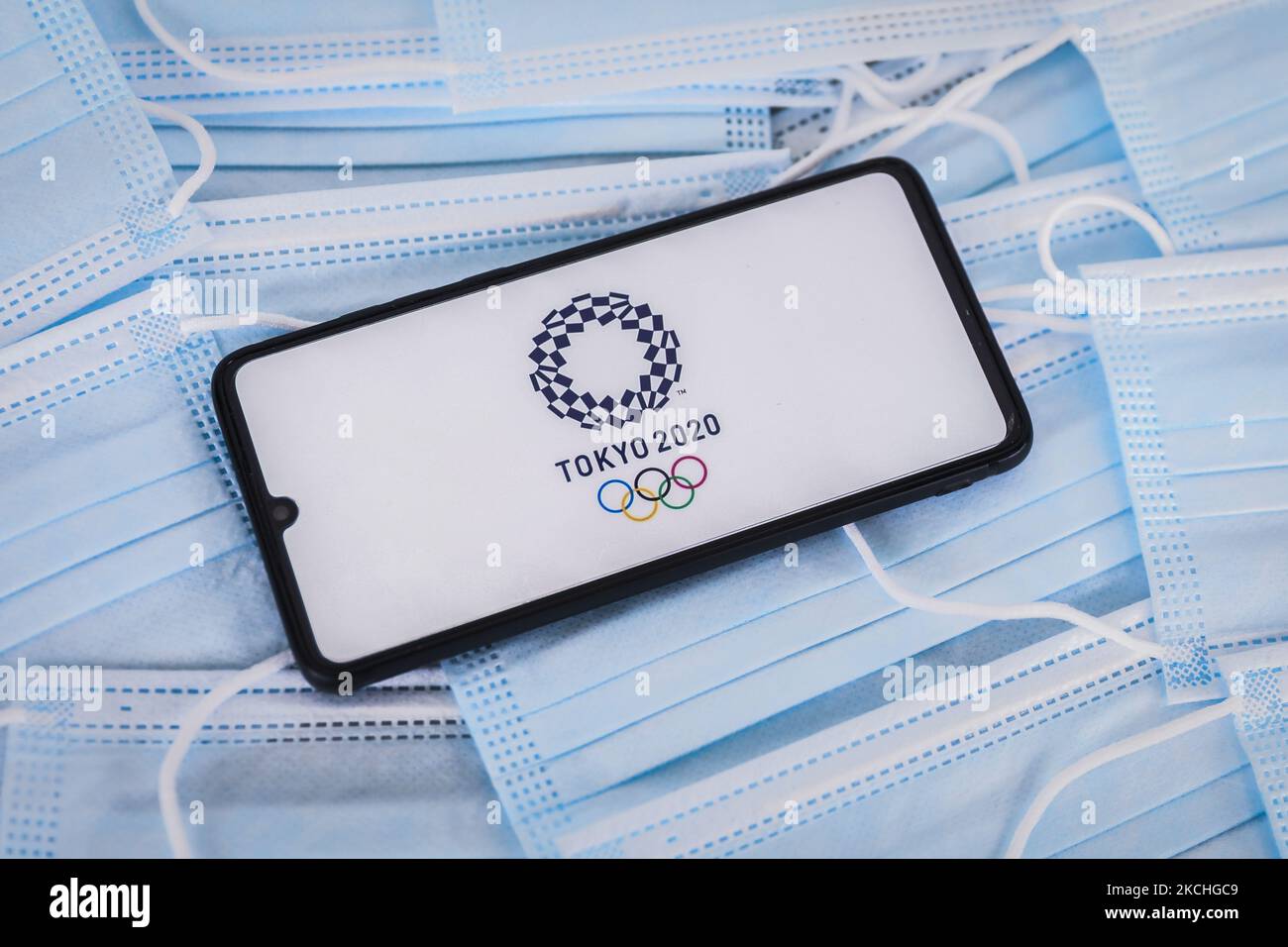 Tokyo 2020 Olympics logo is displayed on a mobile phone screen ...